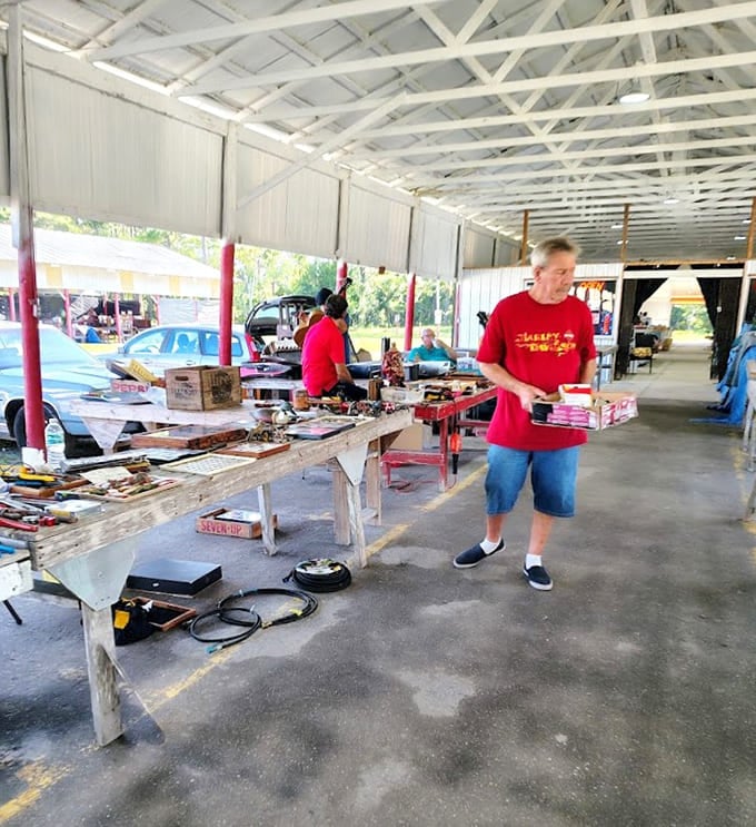Covered stalls protect vendors and their wares while shoppers hunt for deals in comfortable shade.