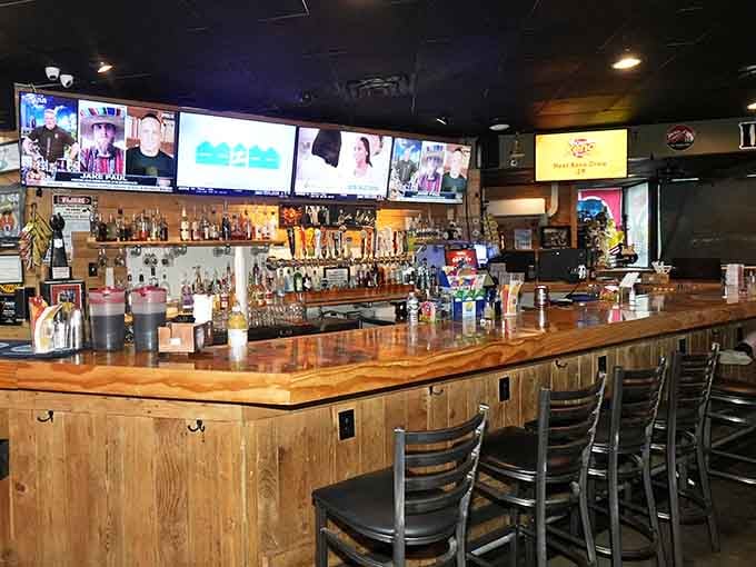 The bar stretches wide with multiple screens, perfect for catching the game while sipping something cold.