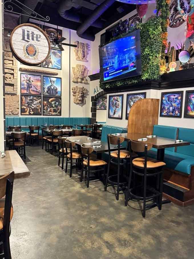 The vibrant artwork and turquoise accents create an atmosphere that's equal parts retro diner and spaceship.