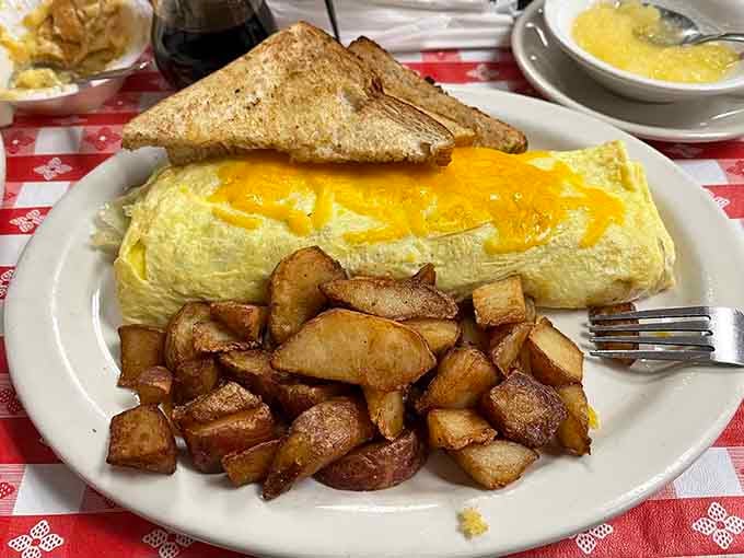 An omelet so perfectly golden it could win beauty pageants, served with home fries and toast for good measure.