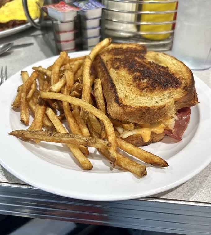 A Reuben sandwich served with fries that are actually crispy&mdash;proof that some places still understand the assignment perfectly.