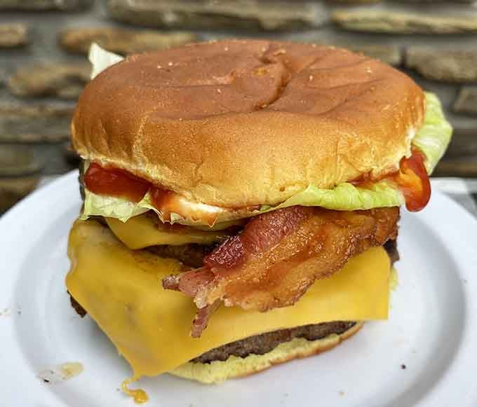 A burger that requires strategic planning to eat—where the cheese melts perfectly and the bacon adds that smoky exclamation point.