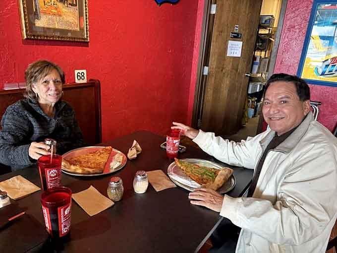 These folks look genuinely happy, probably because they're about to tackle slices bigger than dinner plates.