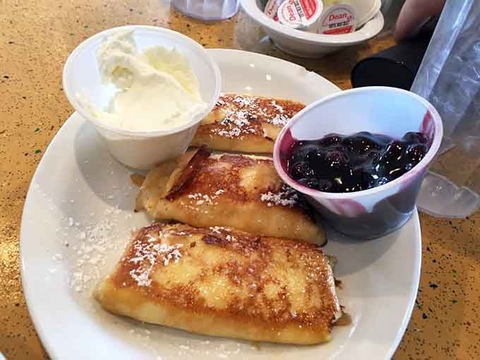 These golden blintzes with their powdered sugar dusting and side of blueberry compote are what breakfast would look like if it wore formal attire.