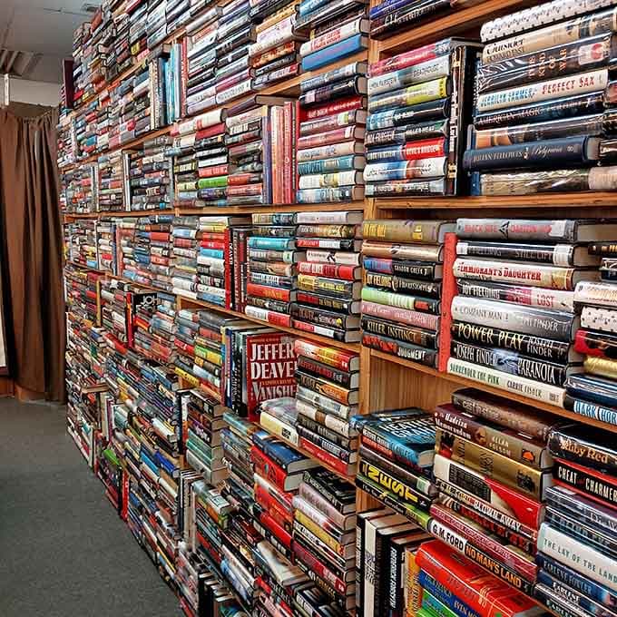 Books stacked horizontally when vertical space runs out – that's not disorganization, that's dedication to maximum inventory and reader happiness.