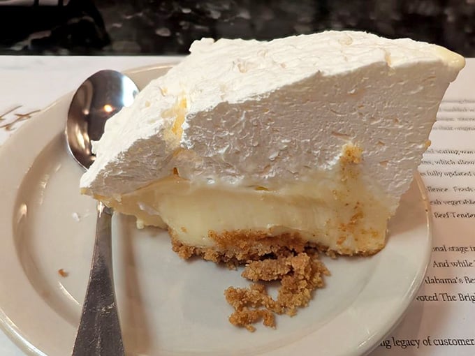This towering slice of meringue pie is basically a cloud that tastes like heaven decided to show off.