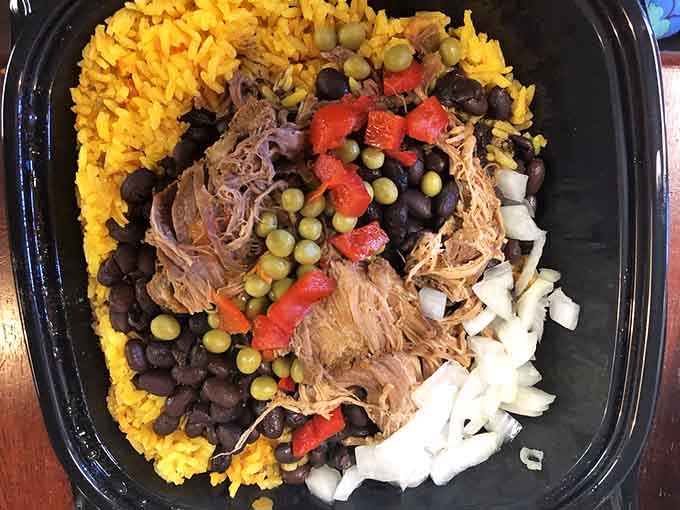 This five-dollar plate of roasted pork, beans, and rice delivers serious comfort food satisfaction.