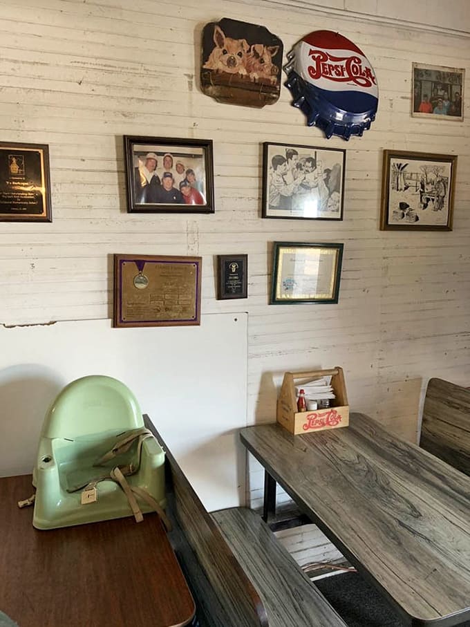 Vintage Pepsi signs and family photos create an atmosphere that feels like eating in someone's beloved rec room from 1975.