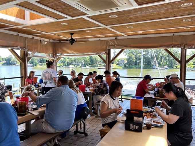 Covered outdoor seating where strangers become friends, united by crabs and that glorious Mill Creek breeze.