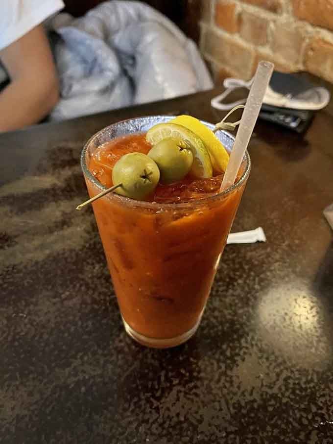A properly garnished Bloody Mary with olives and lemon shows this place takes its brunch beverages seriously too.