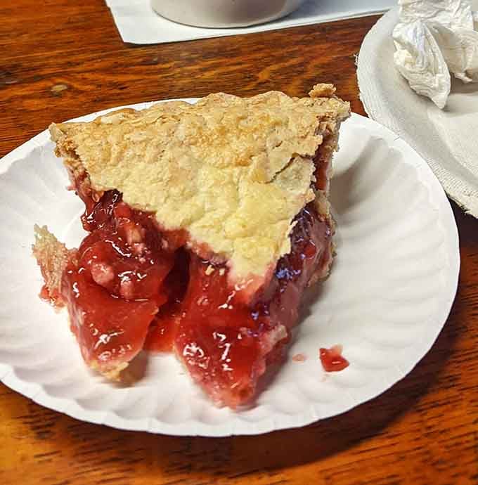 Strawberry rhubarb pie with a golden crust that looks like someone's grandmother made it with actual love and butter.
