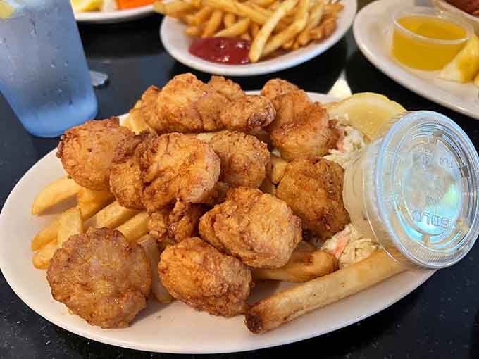 Golden fried scallops pile up like edible treasure, each one a perfectly crispy bite of ocean sweetness.