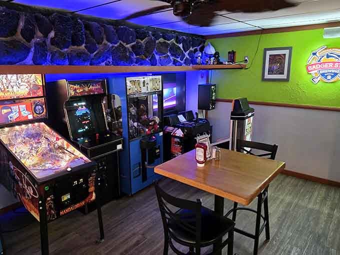 Vintage arcade games and blue mood lighting create the perfect cantina vibe for post-meal entertainment and friendly competition.