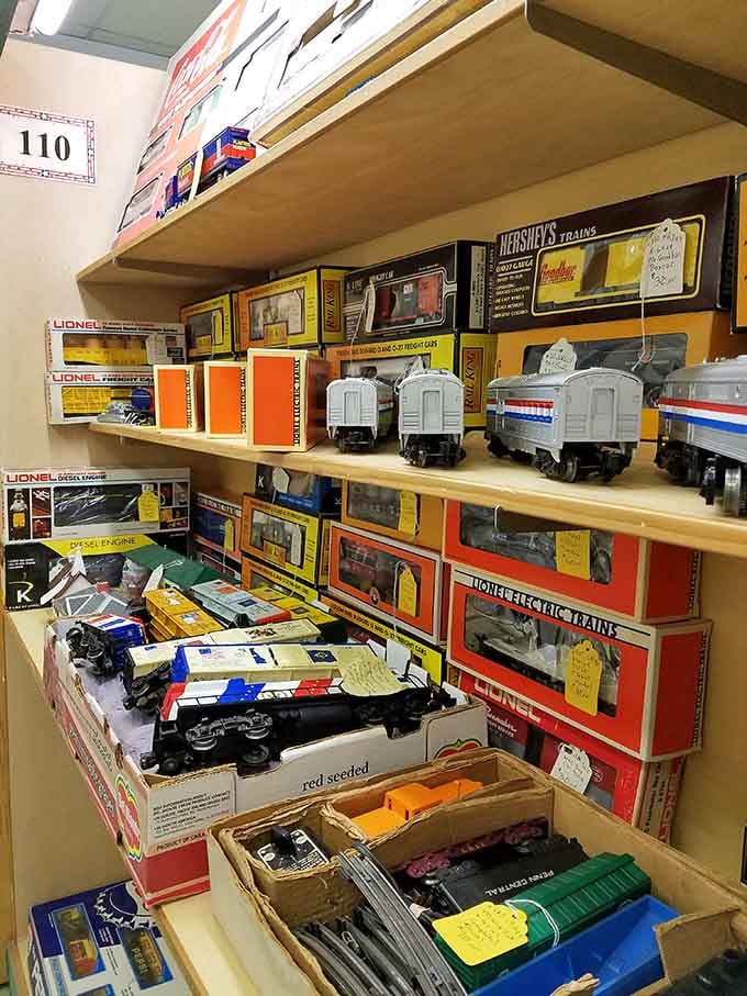 Vintage toy trains still in their boxes, waiting patiently for collectors who remember when Christmas mornings meant unwrapping these beauties.