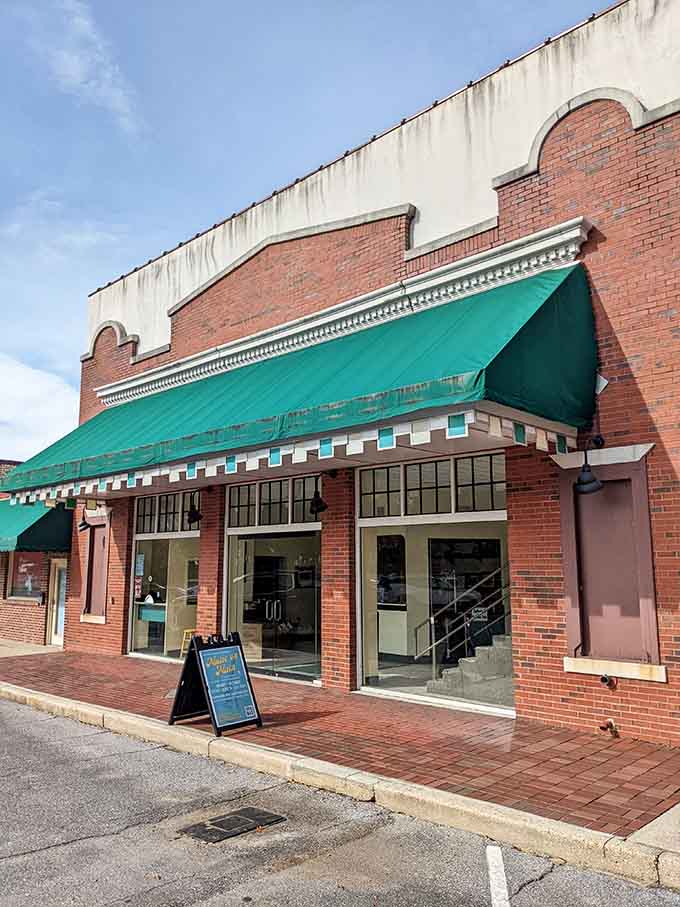 The Chautauqua Theatre's green awnings and brick facade whisper stories of performances that once drew crowds from across the nation.