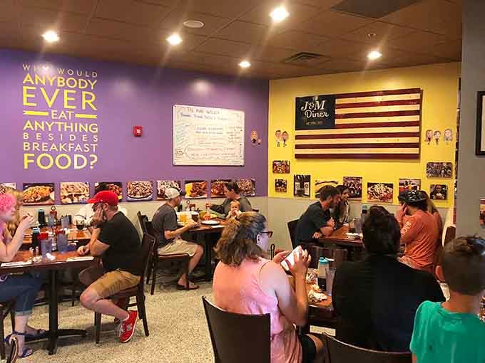 Happy diners enjoying their meals under walls that ask the important questions, like why anyone would eat anything besides breakfast food.