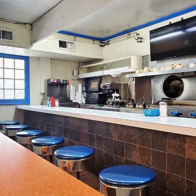 Counter seating with blue vinyl stools where locals have been solving the world's problems for generations.