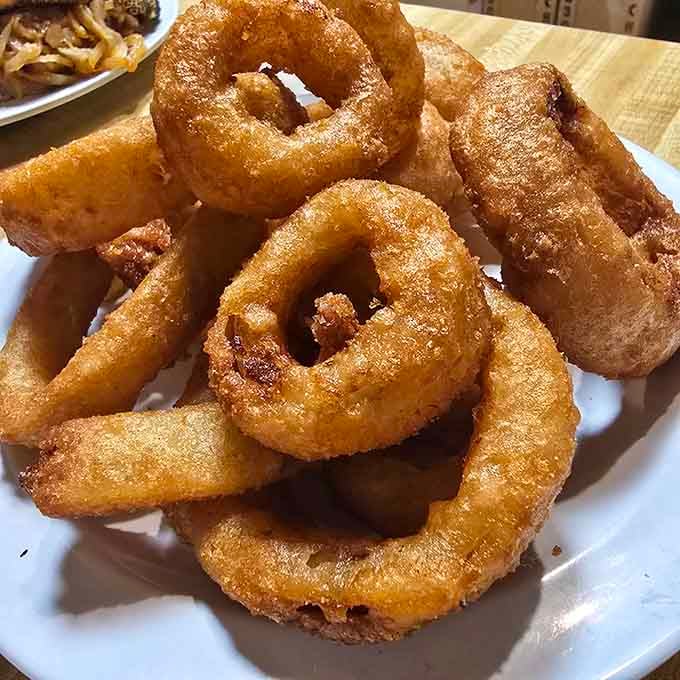 Onion rings with that perfect crunch factor, because every great cheesesteak needs a worthy companion dish.