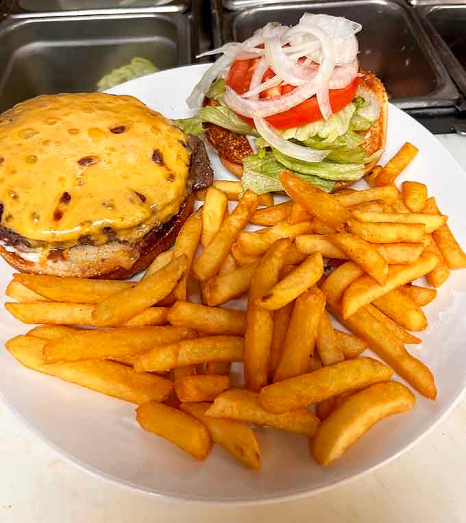 That burger is stacked higher than your expectations, and somehow it still manages to exceed them all anyway.