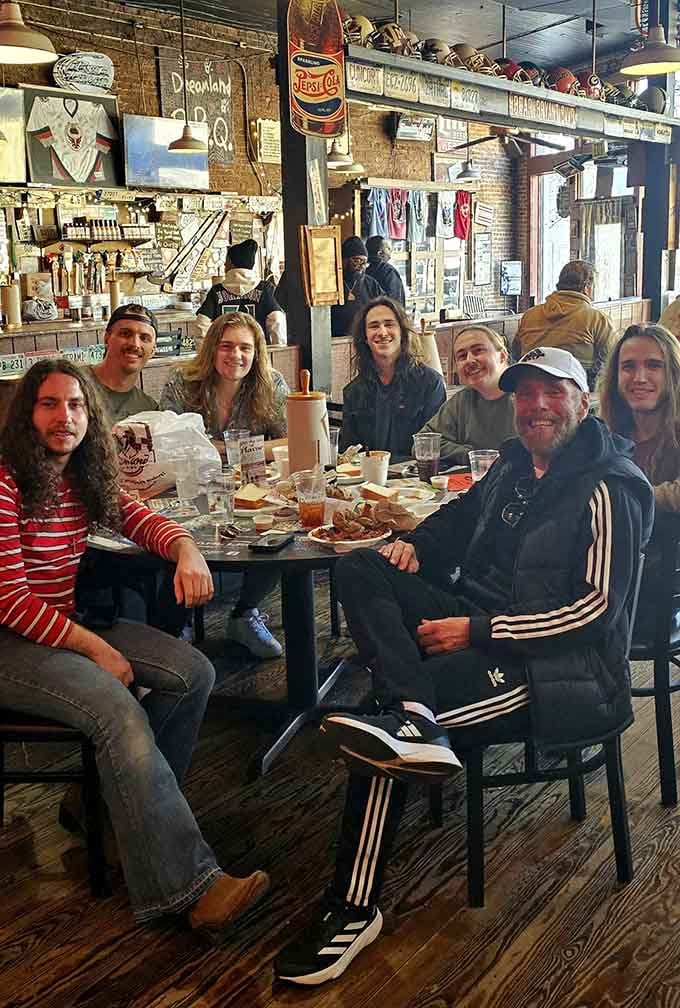 This is what joy looks like: multiple generations gathered around a table, united by smoke and sauce and satisfaction.