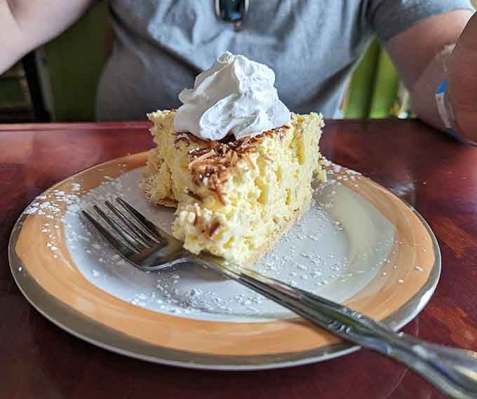 Coconut cream pie so tall and fluffy it could double as a pillow, if pillows were delicious and covered in whipped cream.