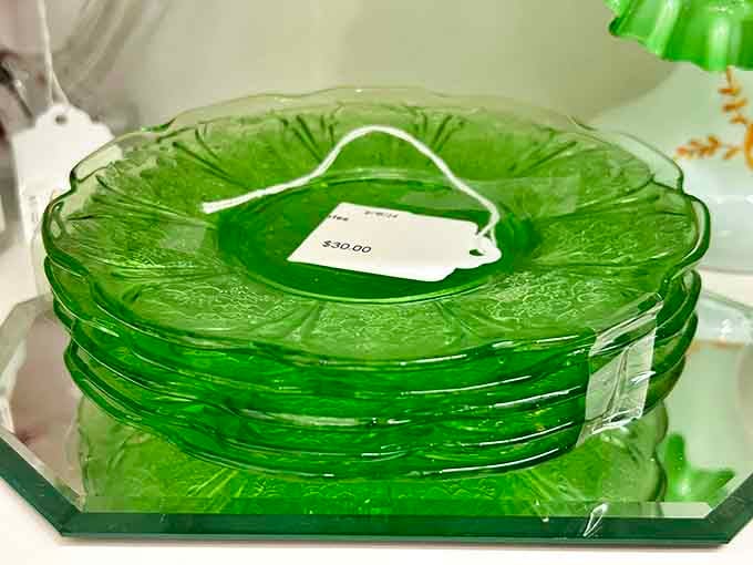 Green Depression glass plates stacked like edible emeralds, turning dinner service into an art exhibition daily.