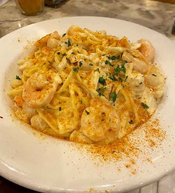 Creamy seafood Alfredo loaded with shrimp proves pasta and ocean treasures make beautiful music together.