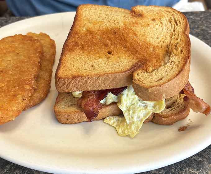 A classic breakfast sandwich on toast with bacon and eggs&mdash;proof that sometimes the simplest combinations are pure genius.