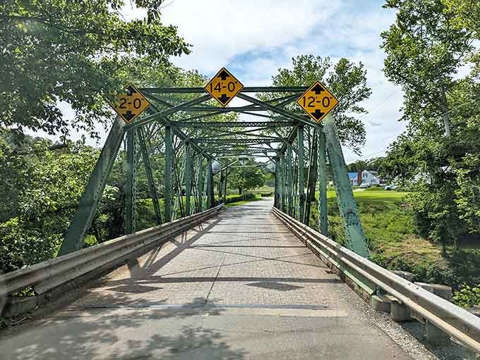 Engineering meets artistry on the Harry Ripley Memorial Bridge. Its green trusses frame the perfect small-town postcard against West Virginia's endless blue sky.