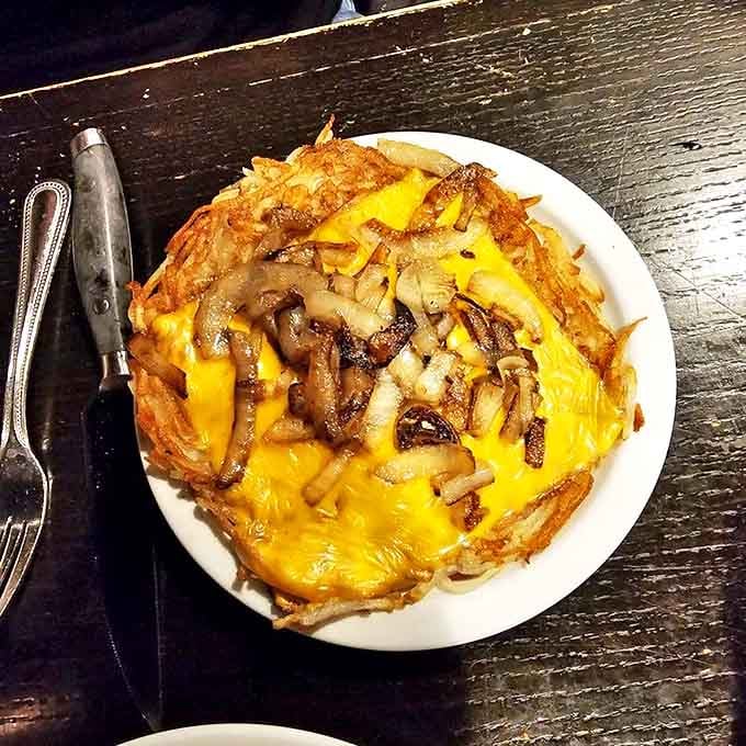 Hashbrowns transformed into an art form with melted cheese and saut&eacute;ed onions. Breakfast food that deserves evening attire.
