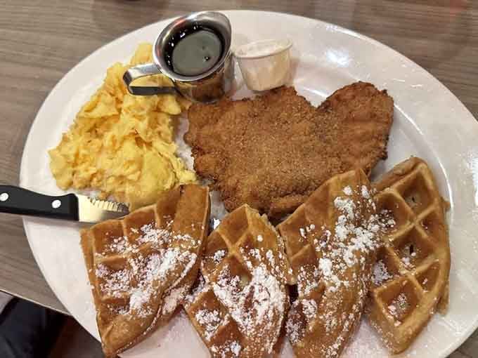 Chicken and waffles dusted with powdered sugar&mdash;because sometimes you need sweet and savory on one plate.