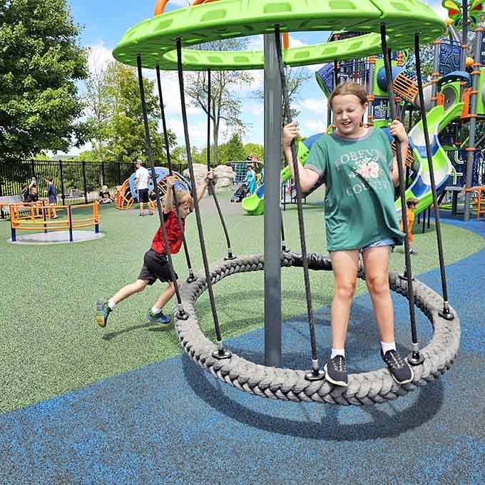 Spinning beneath that bright green canopy feels like stepping into a carefree summer afternoon where laughter never runs out and time slows down just enough to savor the moment.