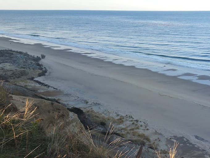 The beach below stretches endlessly, reminding you why people have been drawn to this coastline for centuries.