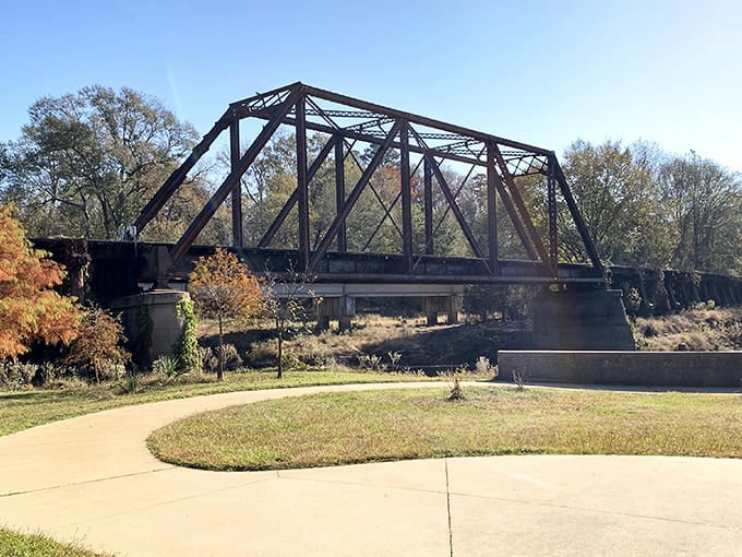The historic railway bridge stands like an industrial sculpture, spanning not just water but connecting modern visitors to Jefferson's transportation legacy.