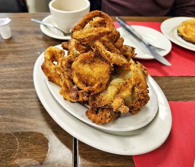 Those onion rings are piled like the Leaning Tower of Pisa, if Pisa were delicious and golden-fried.