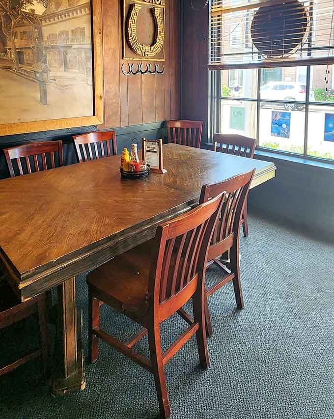 Wooden tables by the window where sunlight streams in, perfect for watching Southport's world go by outside.