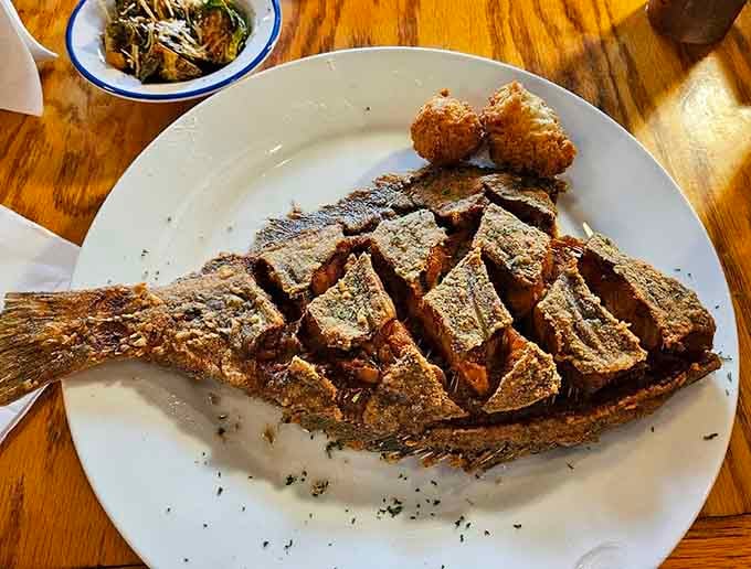Whole fried fish scored and seasoned, looking like it swam straight from ocean to your eager plate.