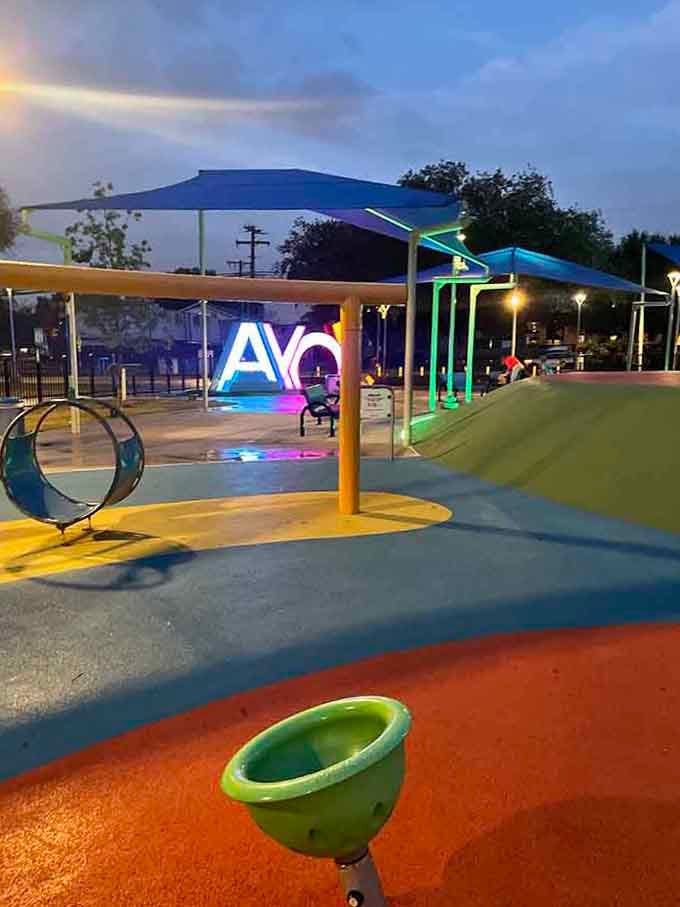 The glowing sign at dusk creates Instagram-worthy moments while kids create memories that'll last way longer than any photo.