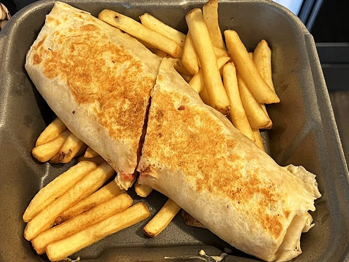 A shawarma wrap so generously stuffed it requires both hands and possibly a strategic eating plan to conquer successfully.