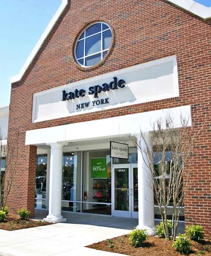 Kate Spade's elegant storefront promises colorful sophistication at outlet prices. The 60% off sign is the siren call no shopper can resist.
