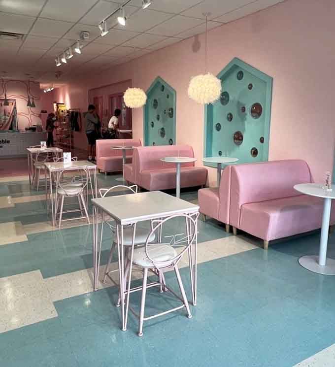 Pink sofas and turquoise cat condos create a color scheme that's equal parts Miami Vice and feline paradise.