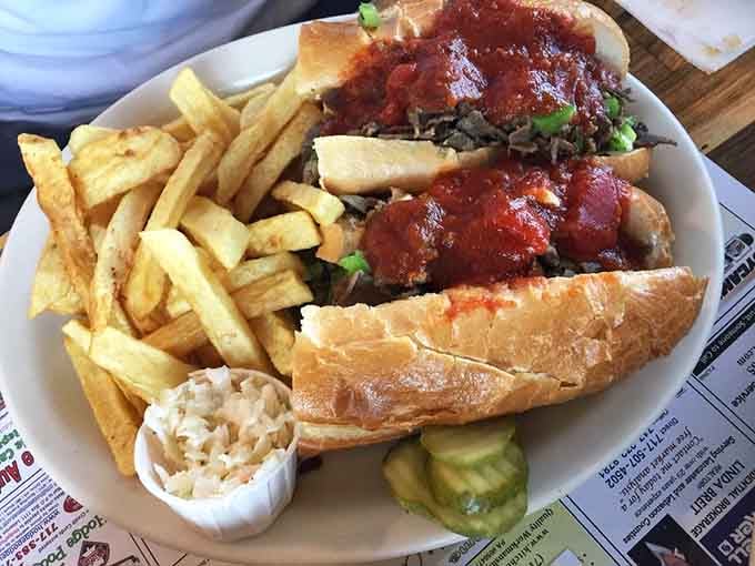 A Philly sandwich piled high with meat and topped with sauce, served with fries that could be a meal all by themselves.