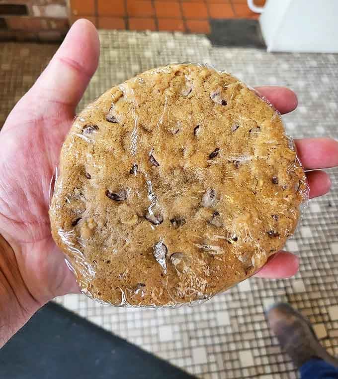 A chocolate chip cookie the size of your palm, wrapped and ready to be your new best friend for the drive home.