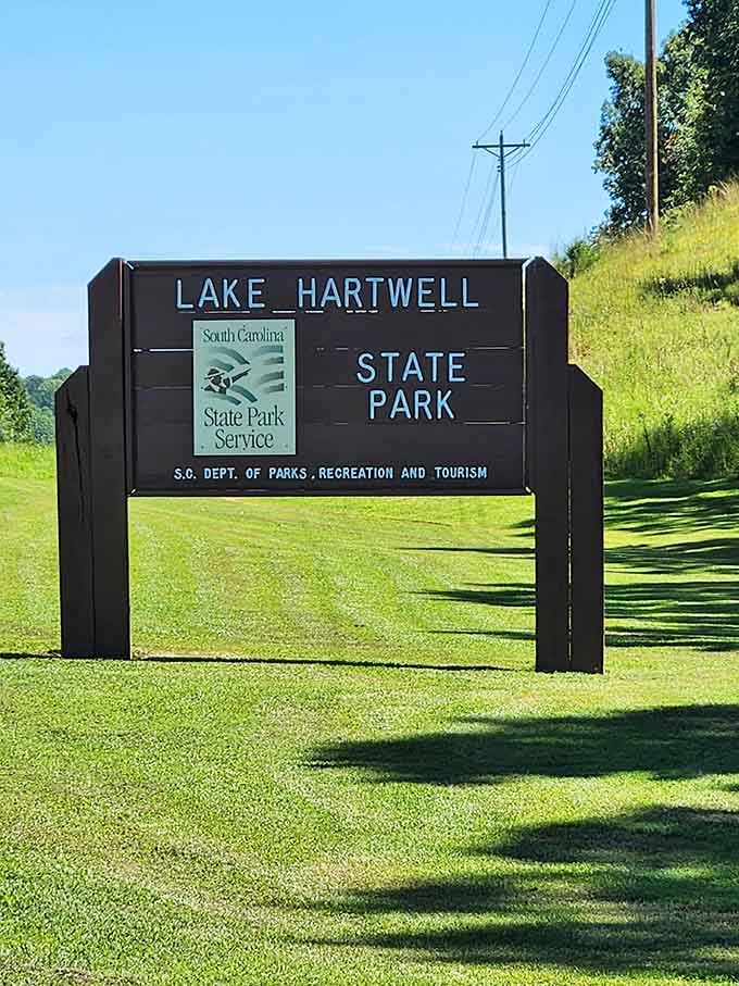 The welcoming park sign marks your official entry into a world where stress takes a permanent vacation.