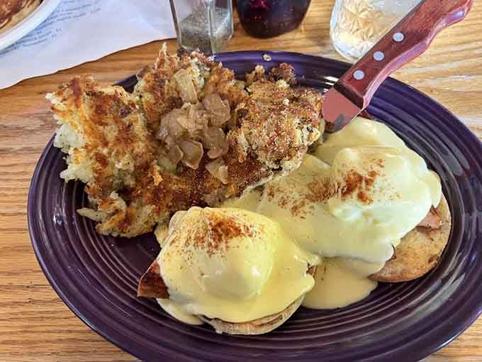 Perfectly poached eggs crown this Benedict, proving the kitchen staff has mastered one of breakfast's trickiest techniques.