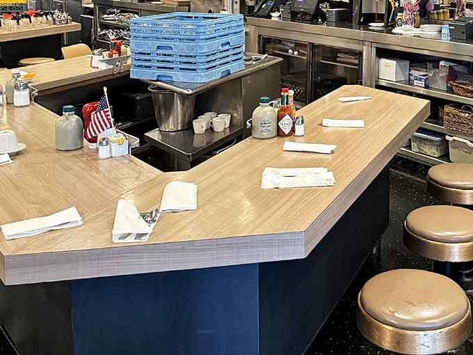 Counter seating where solo diners become temporary neighbors, sharing space and occasionally stealing glances at each other's breakfast choices.