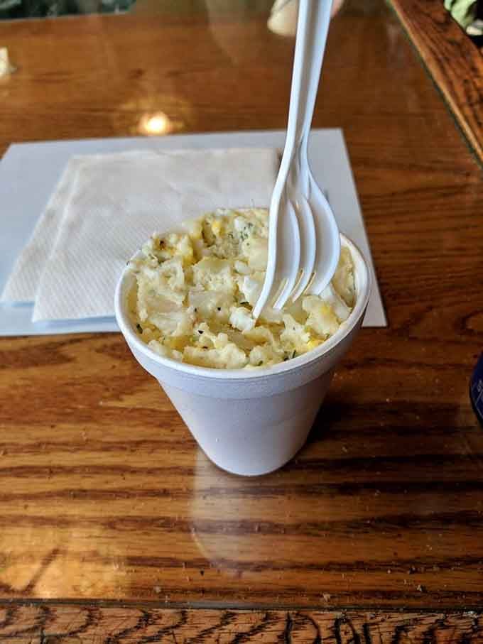 Classic potato salad served simply in a cup, because not everything needs to be deconstructed or reimagined unnecessarily.