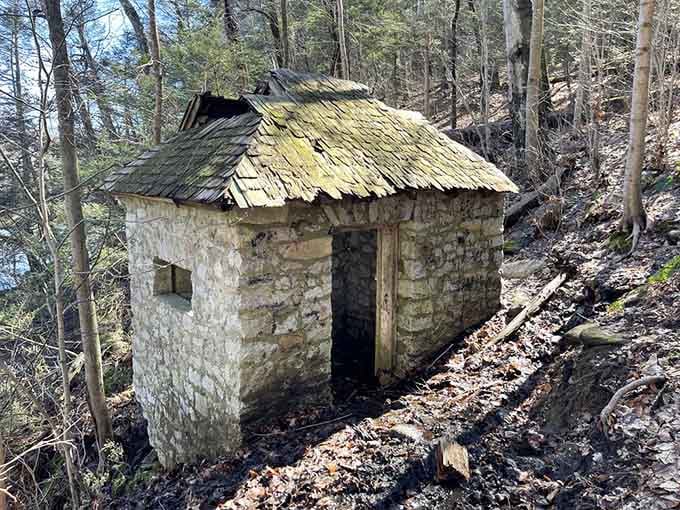 The Indian Spring House stands as a charming stone relic, looking mysteriously purposeful among the trees.
