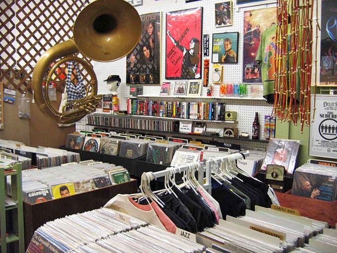 That tuba looming over vinyl records like a brass guardian angel protecting the soundtrack of everyone's youth from the Beatles to Zeppelin.