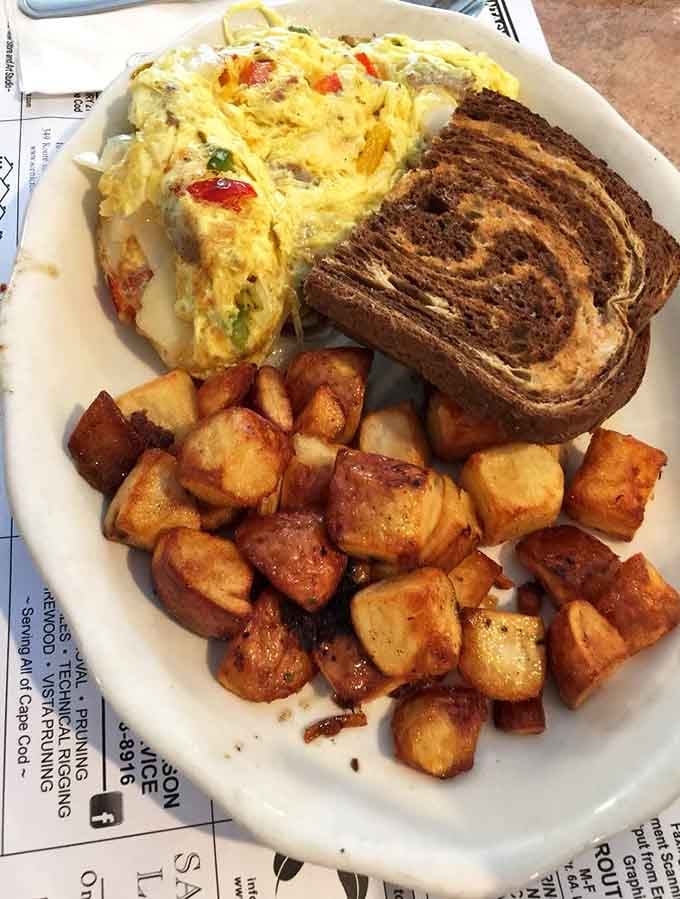 That omelet with perfectly browned rye toast and home fries is what happens when a kitchen respects the art of breakfast cooking.